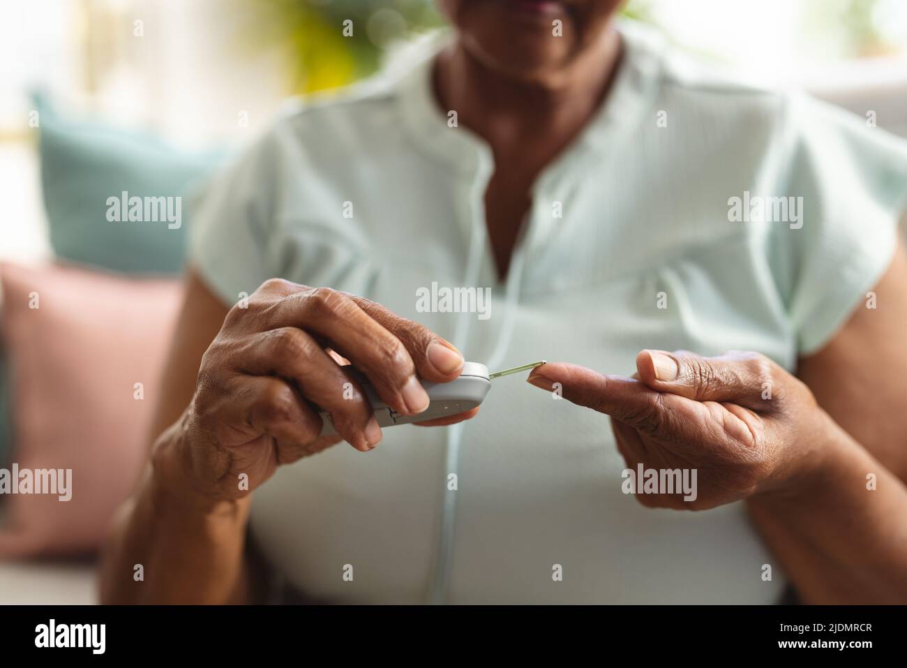 Midsection of african american senior woman examining sugar with ...