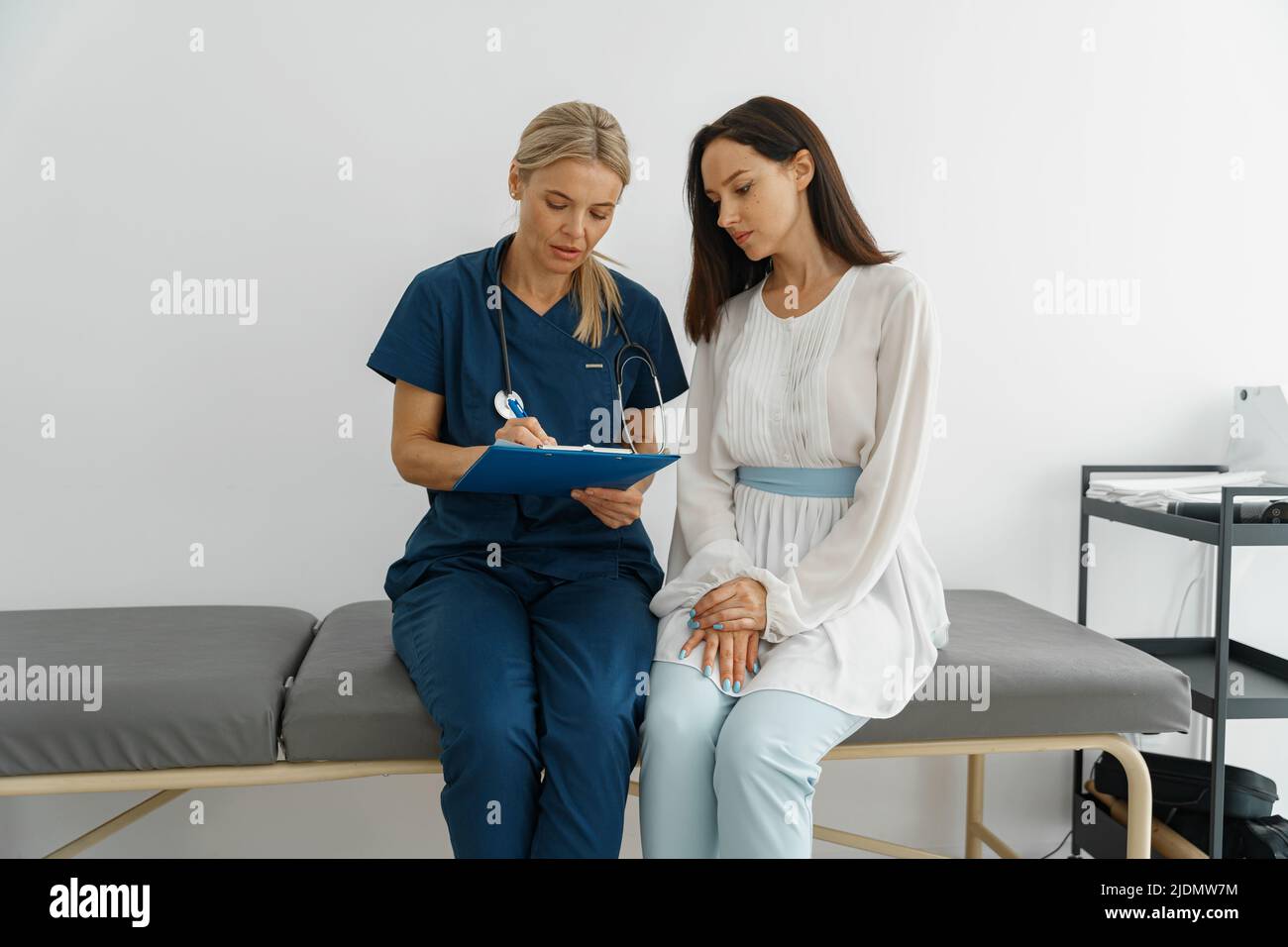 Doctor fills out the medical report form on medical care of patients ...