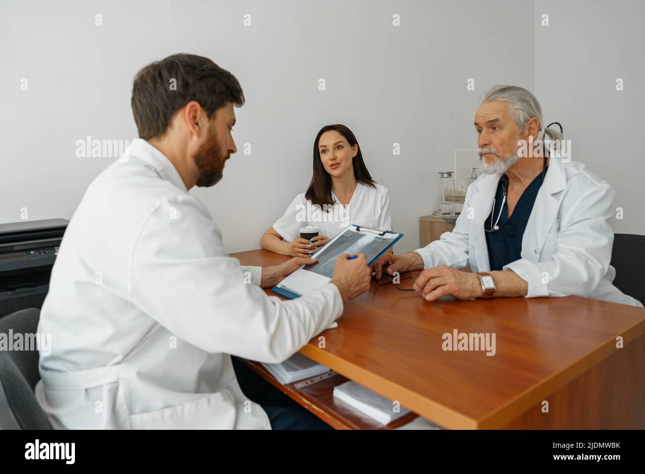 Successful medical doctors are discussing diagnosis during the ...
