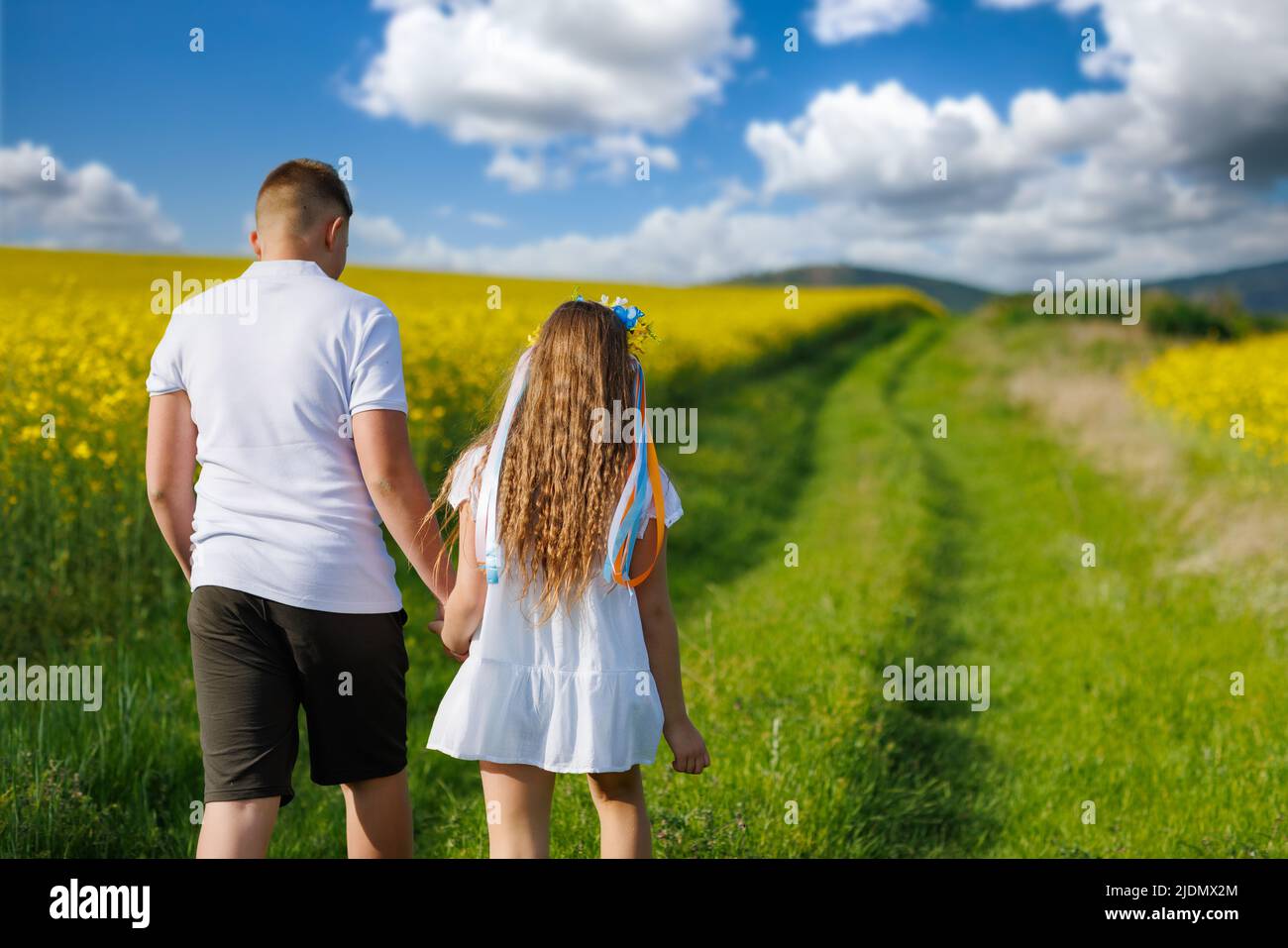 Rear view of happy carefree native children: older teenage brother and ...