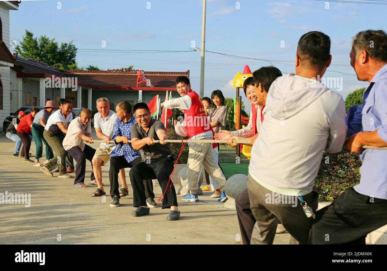 HAI'AN, CHINA - JUNE 22, 2022 - Villagers play tug-of-war in front of ...