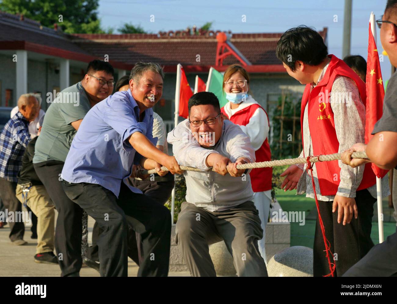 HAI'AN, CHINA - JUNE 22, 2022 - Villagers play tug-of-war in front of ...