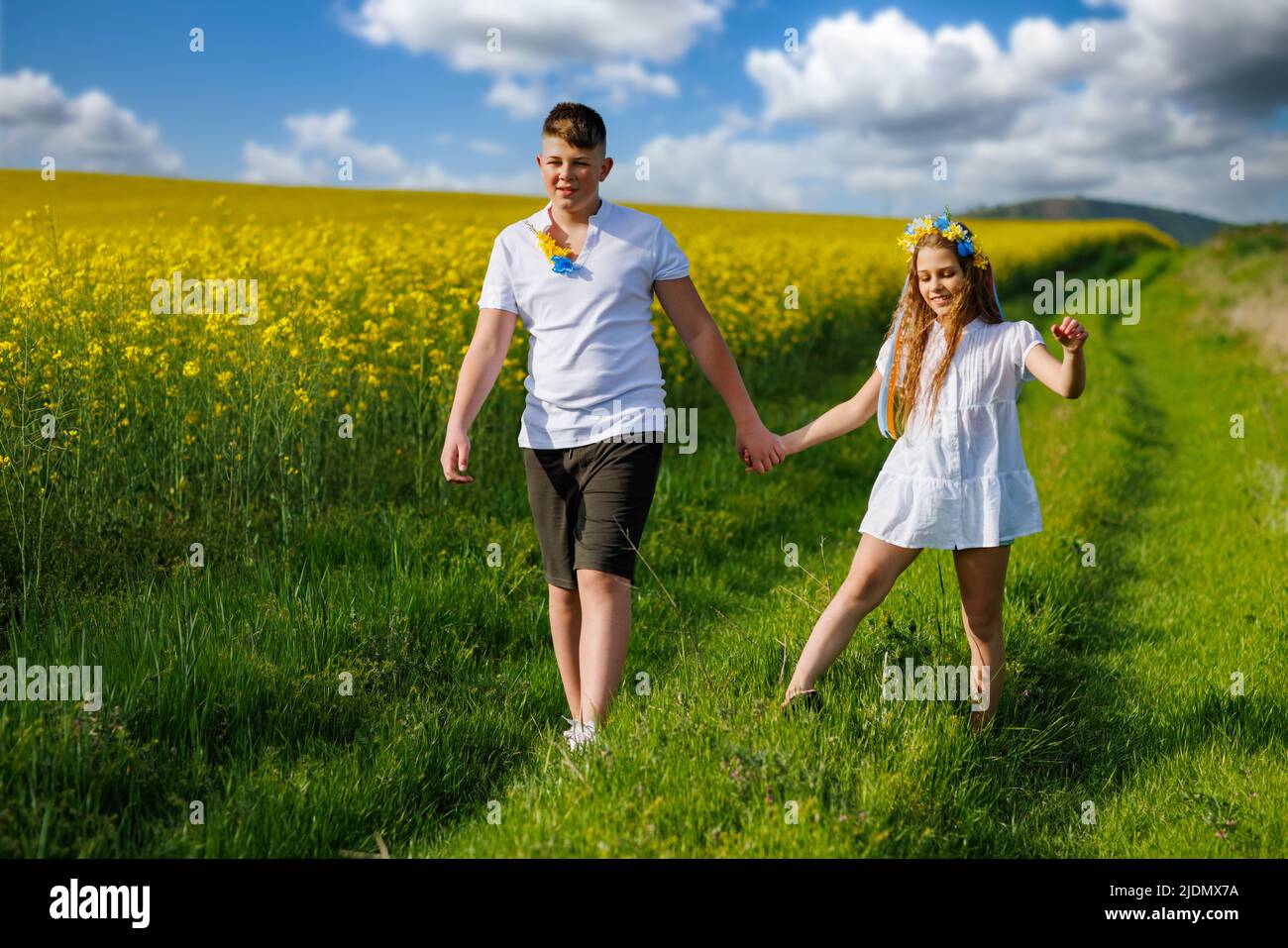 Front view of happy carefree native children: older teenage brother and ...
