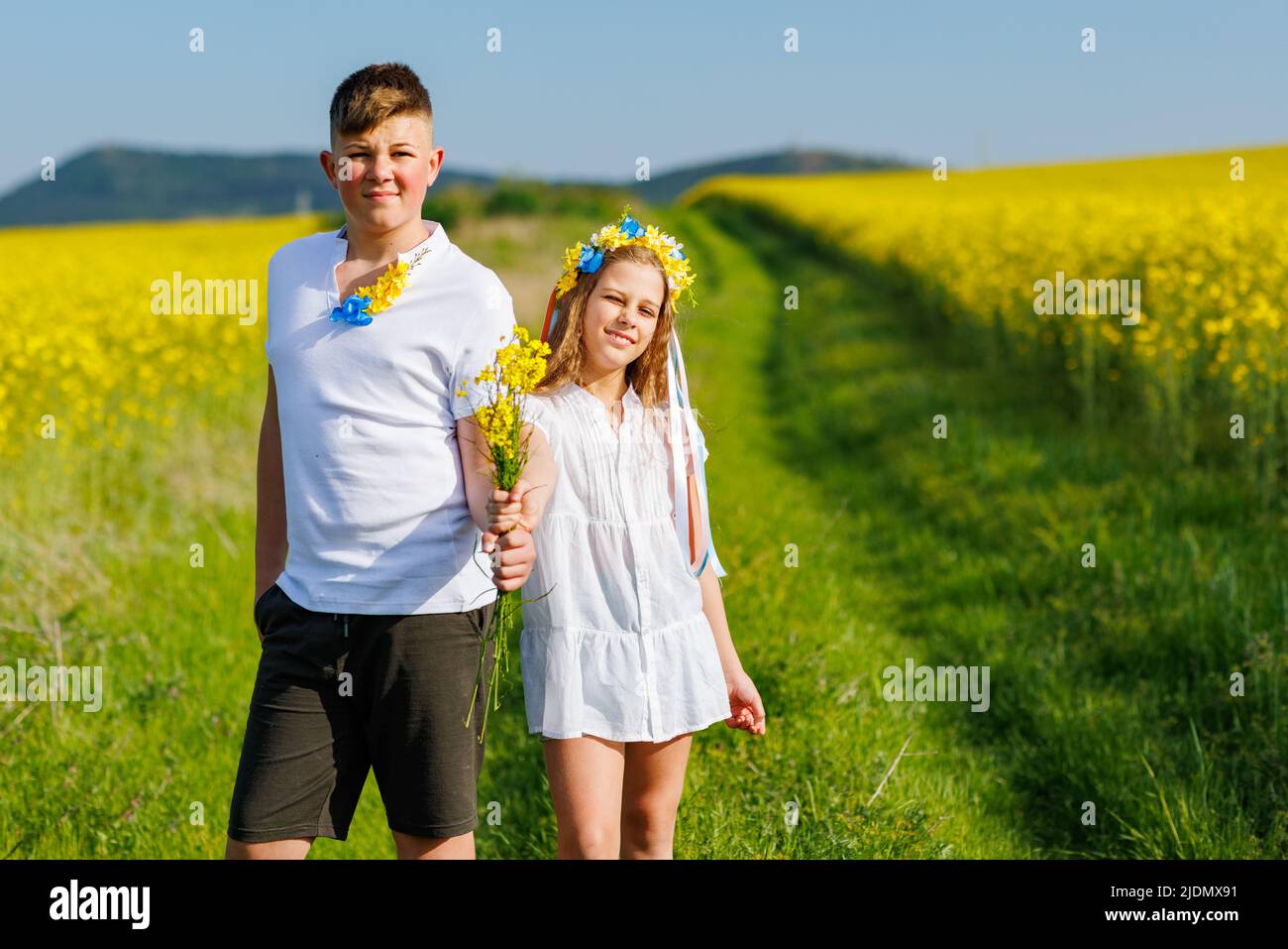 Front view of happy carefree native children: older teenage brother and ...
