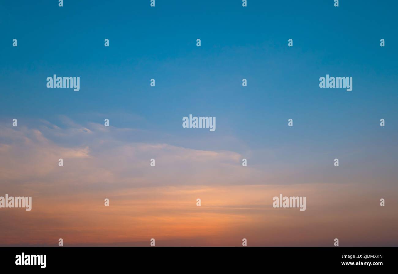 Bright orange sunset sky background with gentle colorful clouds, soft ...