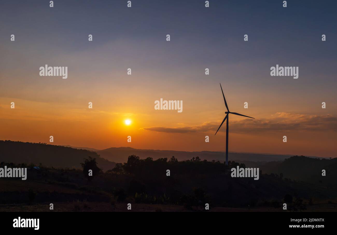 Wind turbine farm on mountain landscape at sunset sky background. Wind ...