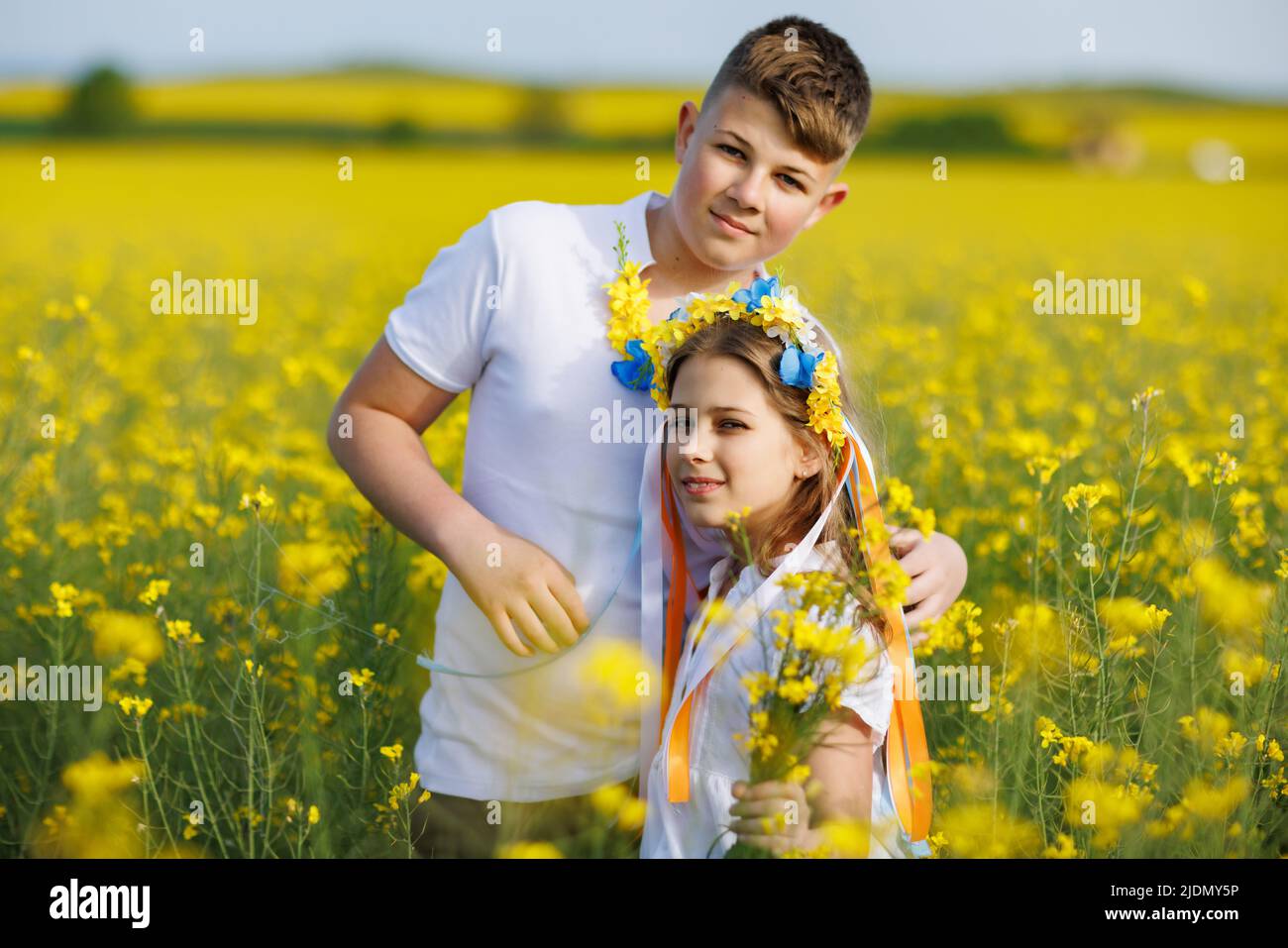 Front view of happy carefree native children: older teenage brother and ...