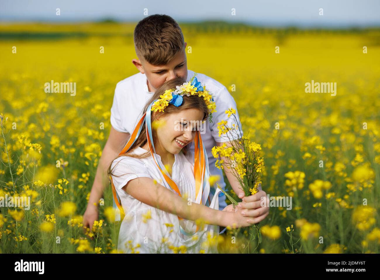 Front view of happy carefree native children: older teenage brother and ...