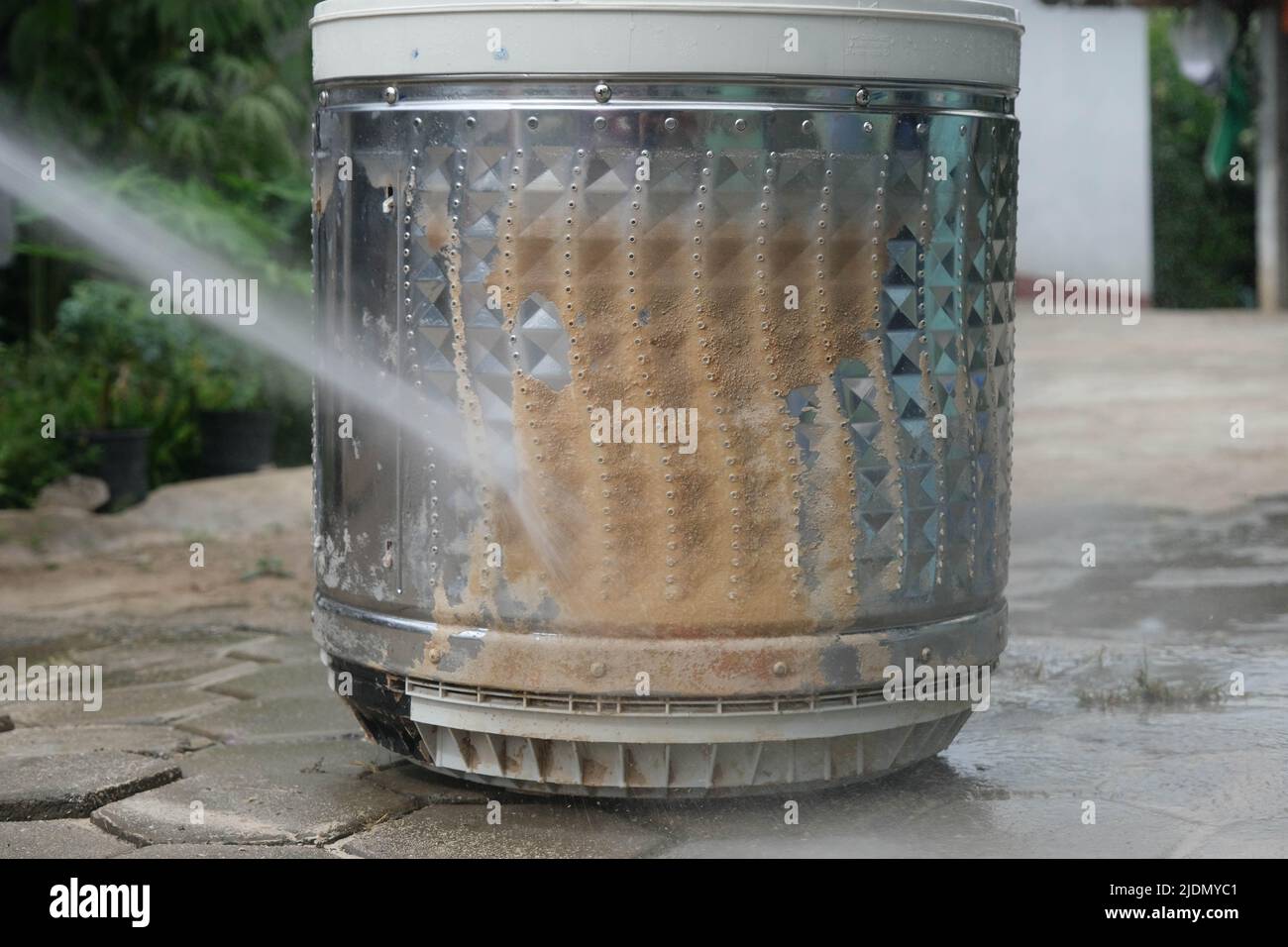 Close-up of washing machine drum descaling with high-pressure cleaner ...