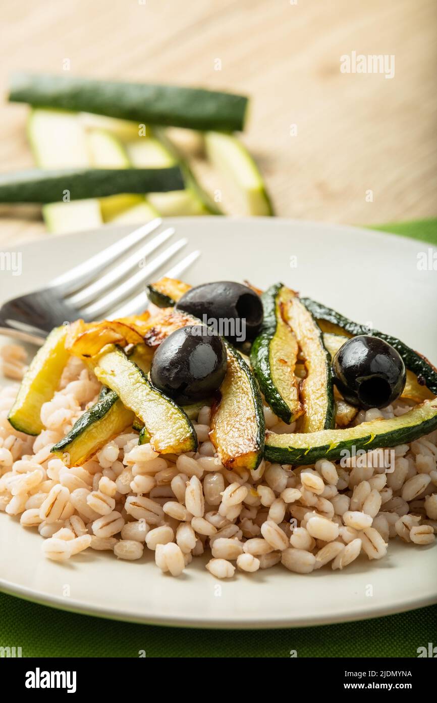 Pearl barley salad with zucchini, tuna and olives Stock Photo - Alamy