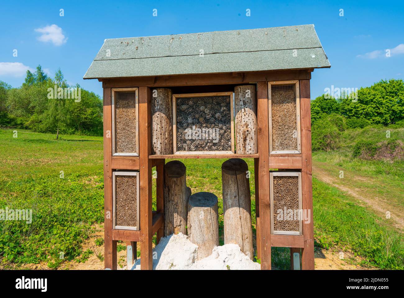 Insect hotel in a green hedge gives protection. Wooden insect house ...