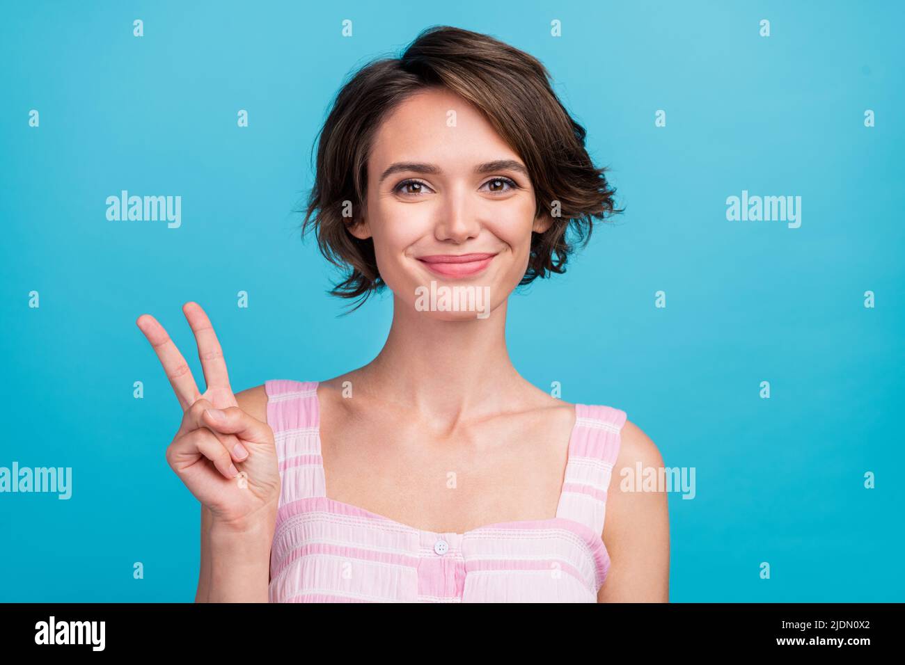 Photo of funny millennial fancy lady show v-sign wear pink top isolated ...