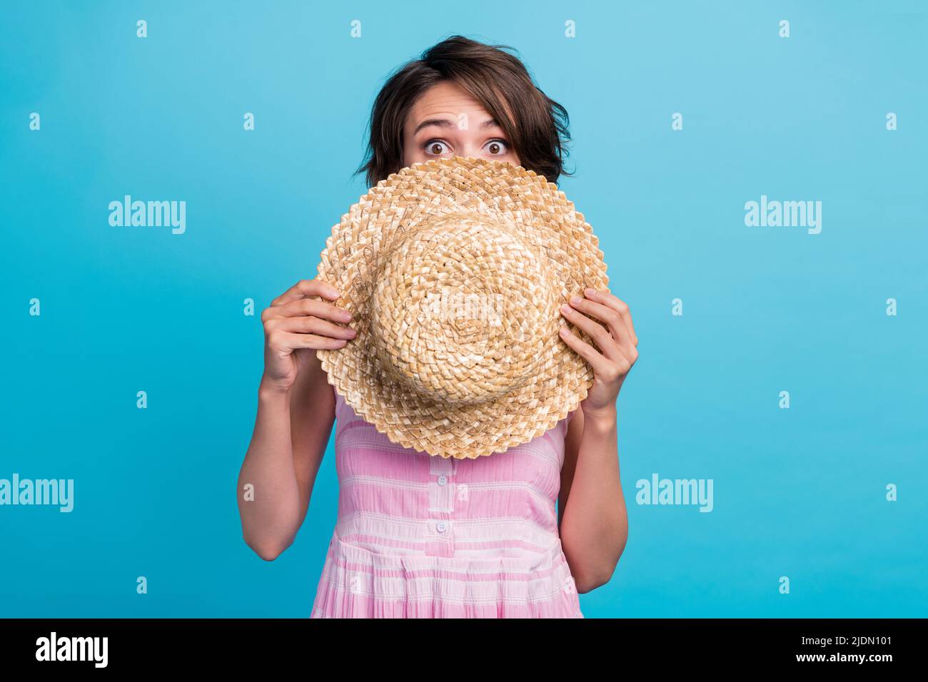 Photo of scared millennial lady hide face hold panama wear pink dress ...