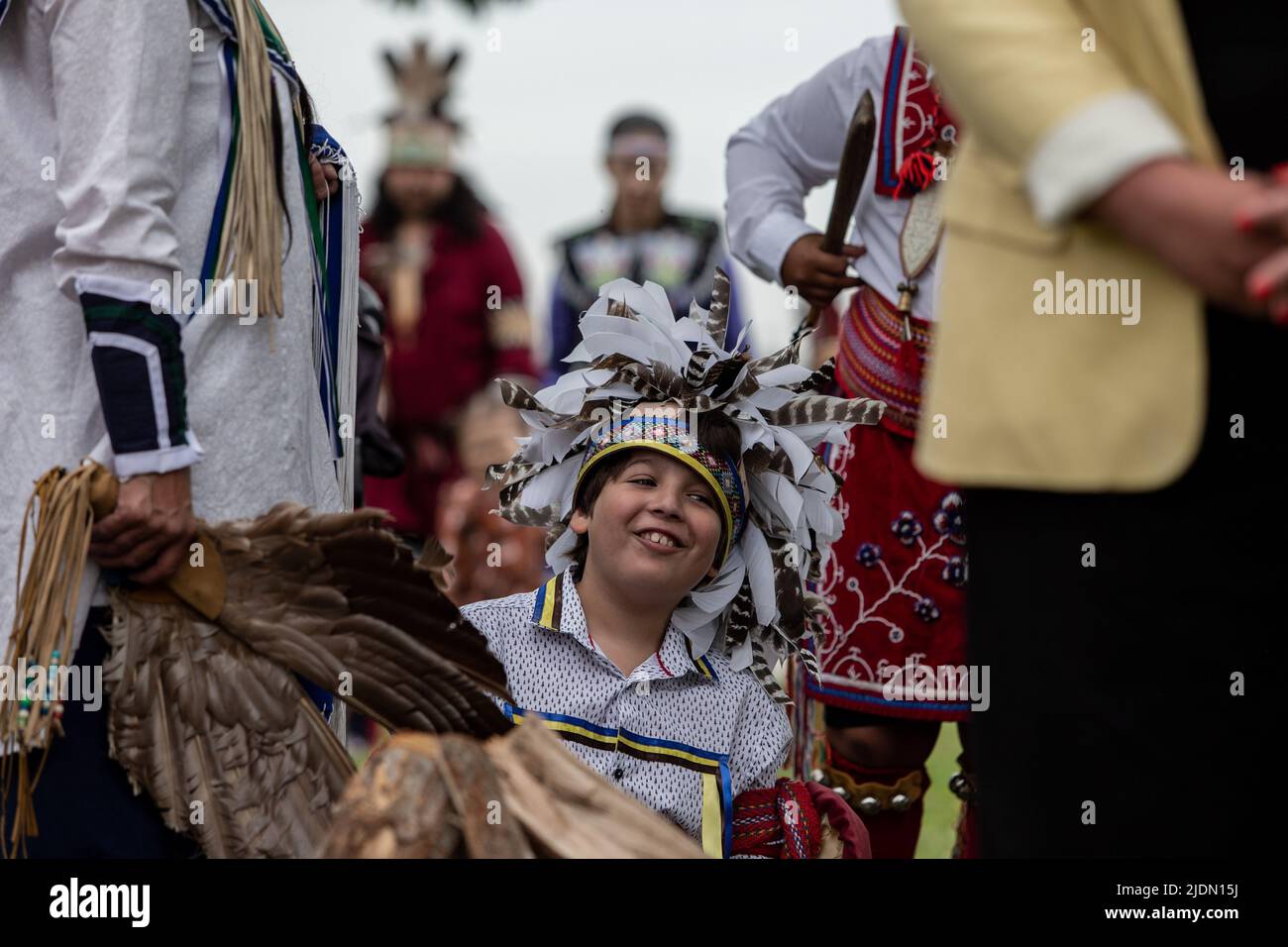 An Indigenous enfant surrounded by their family during the celebration ...