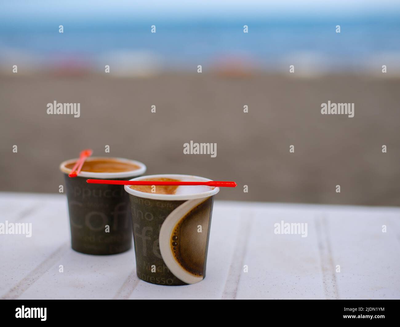 Two cups of coffee to go on the beach in close up mode Stock Photo - Alamy