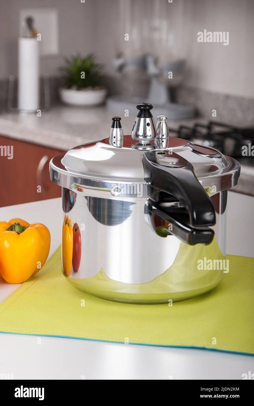 Double valve pressure cooker on white background Stock Photo - Alamy