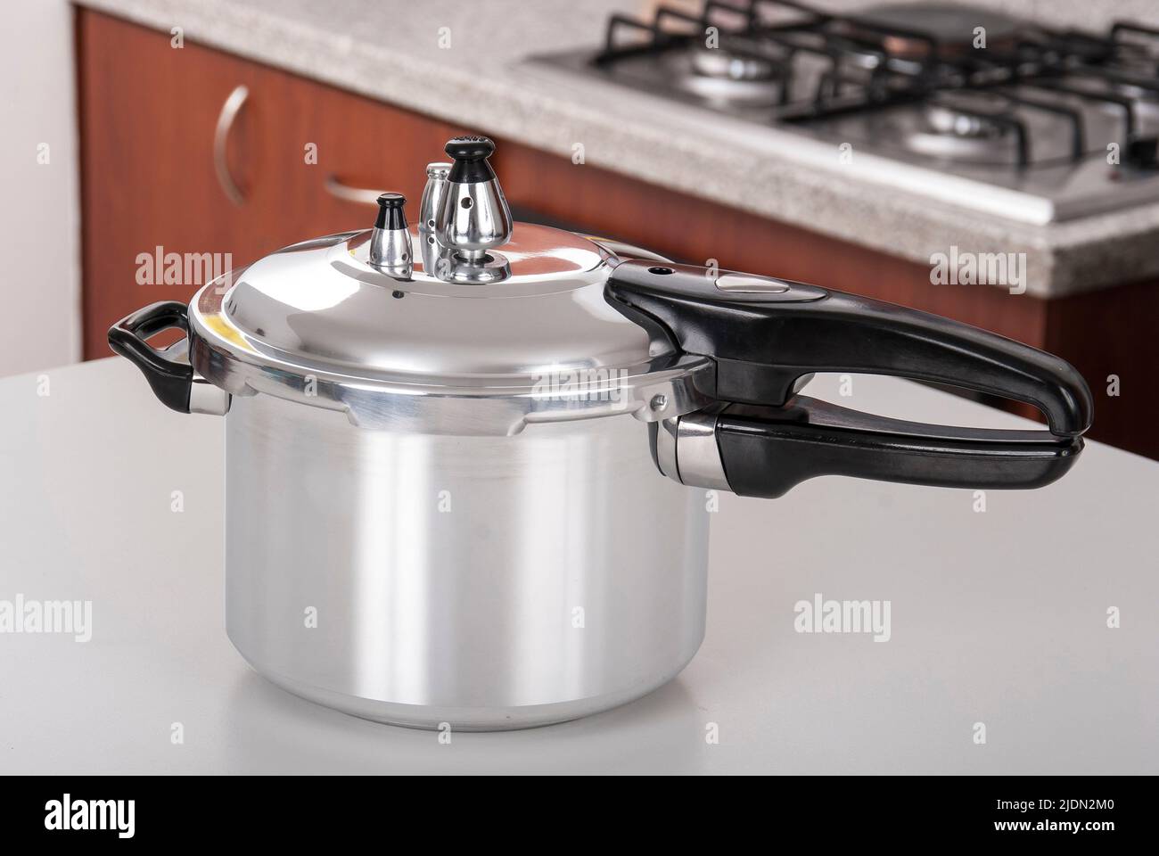 Double valve pressure cooker on white background Stock Photo - Alamy