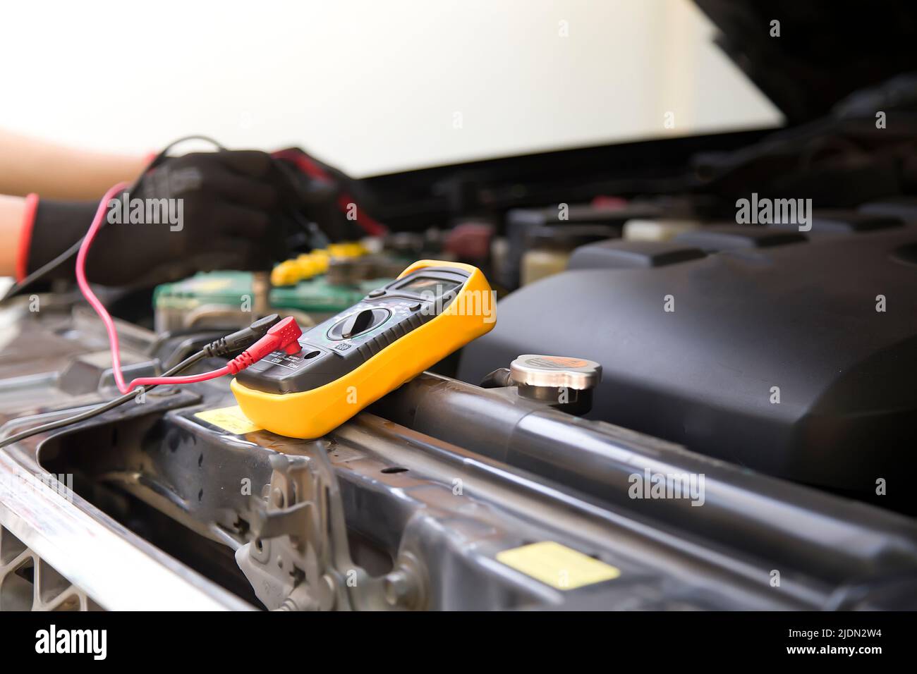 A technician is checking the car battery for availability Stock Photo ...