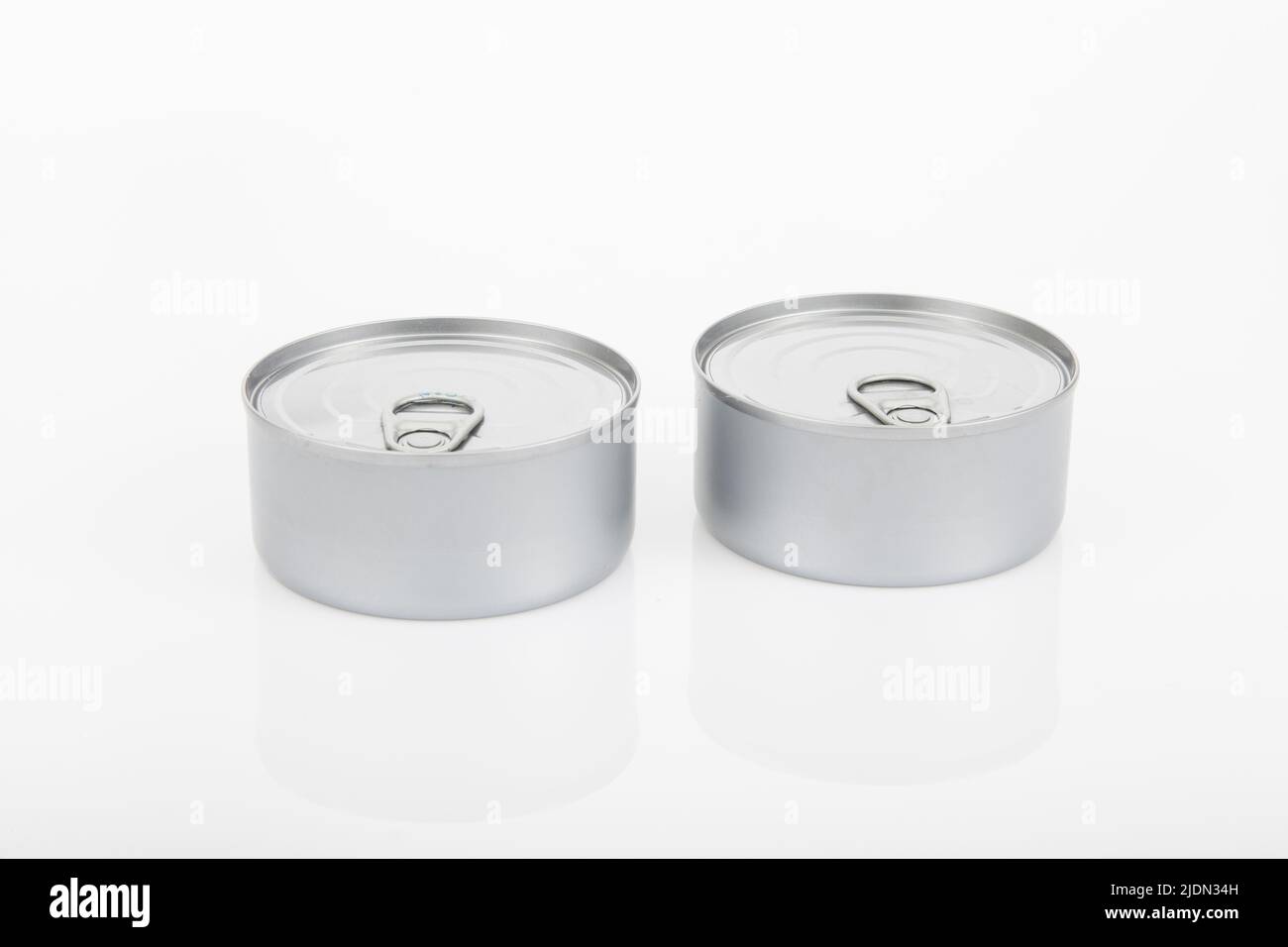 two cans of tuna on white background Stock Photo - Alamy