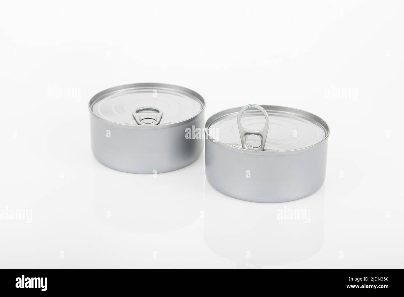 two cans of tuna on white background Stock Photo - Alamy