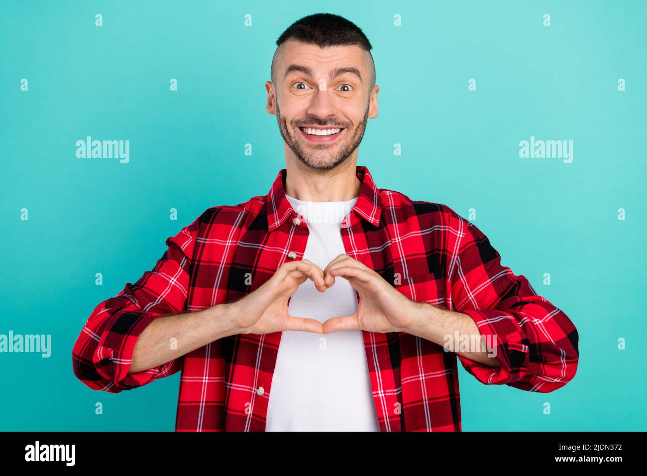 Photo of lovely millennial brunet guy show heart wear red shirt ...