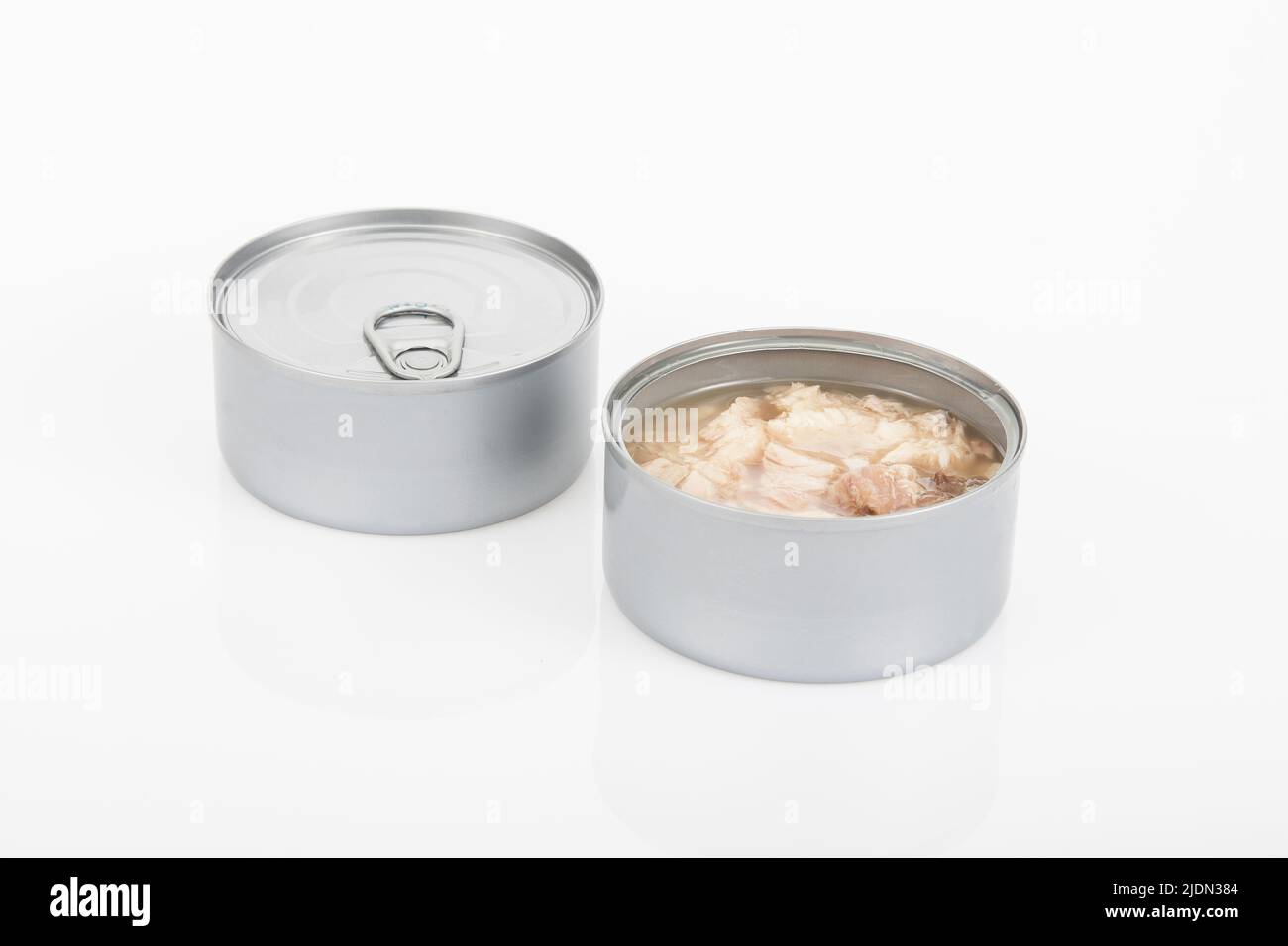 two cans of tuna on white background Stock Photo - Alamy