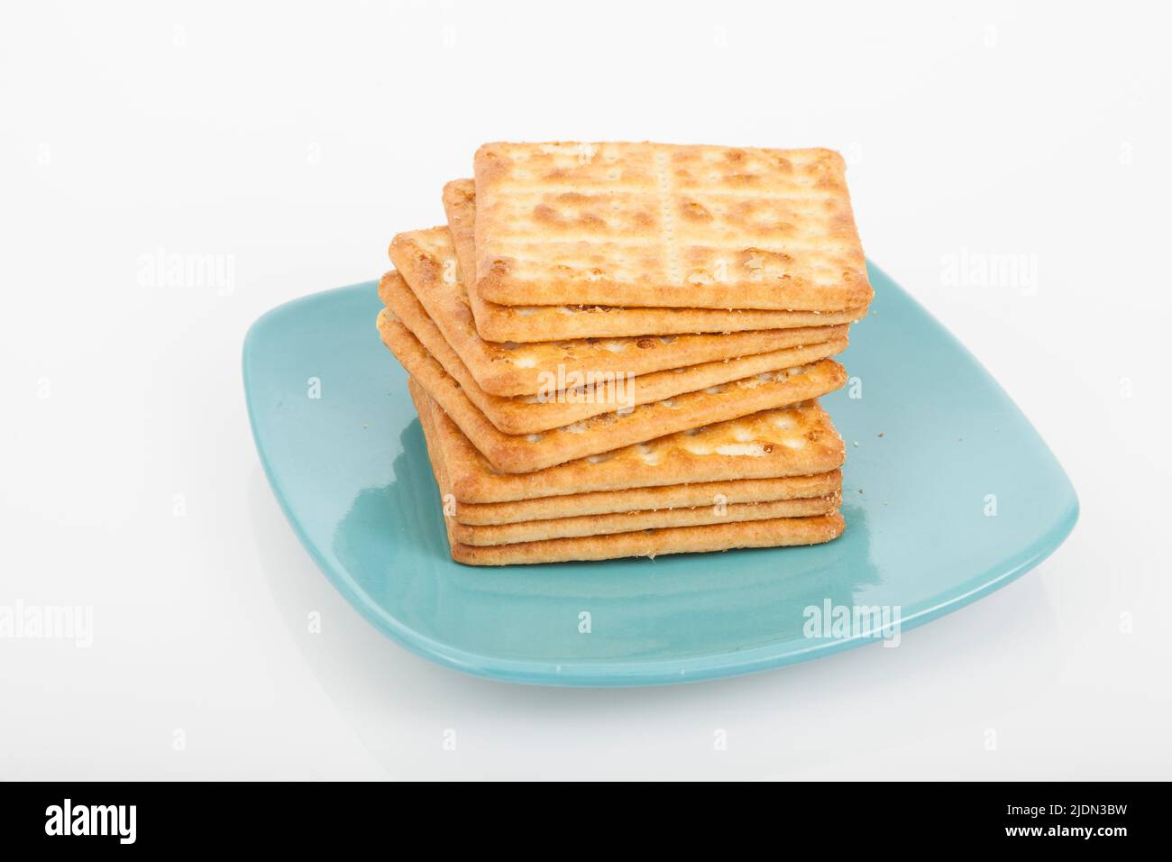 crackers on a plate on white background Stock Photo - Alamy
