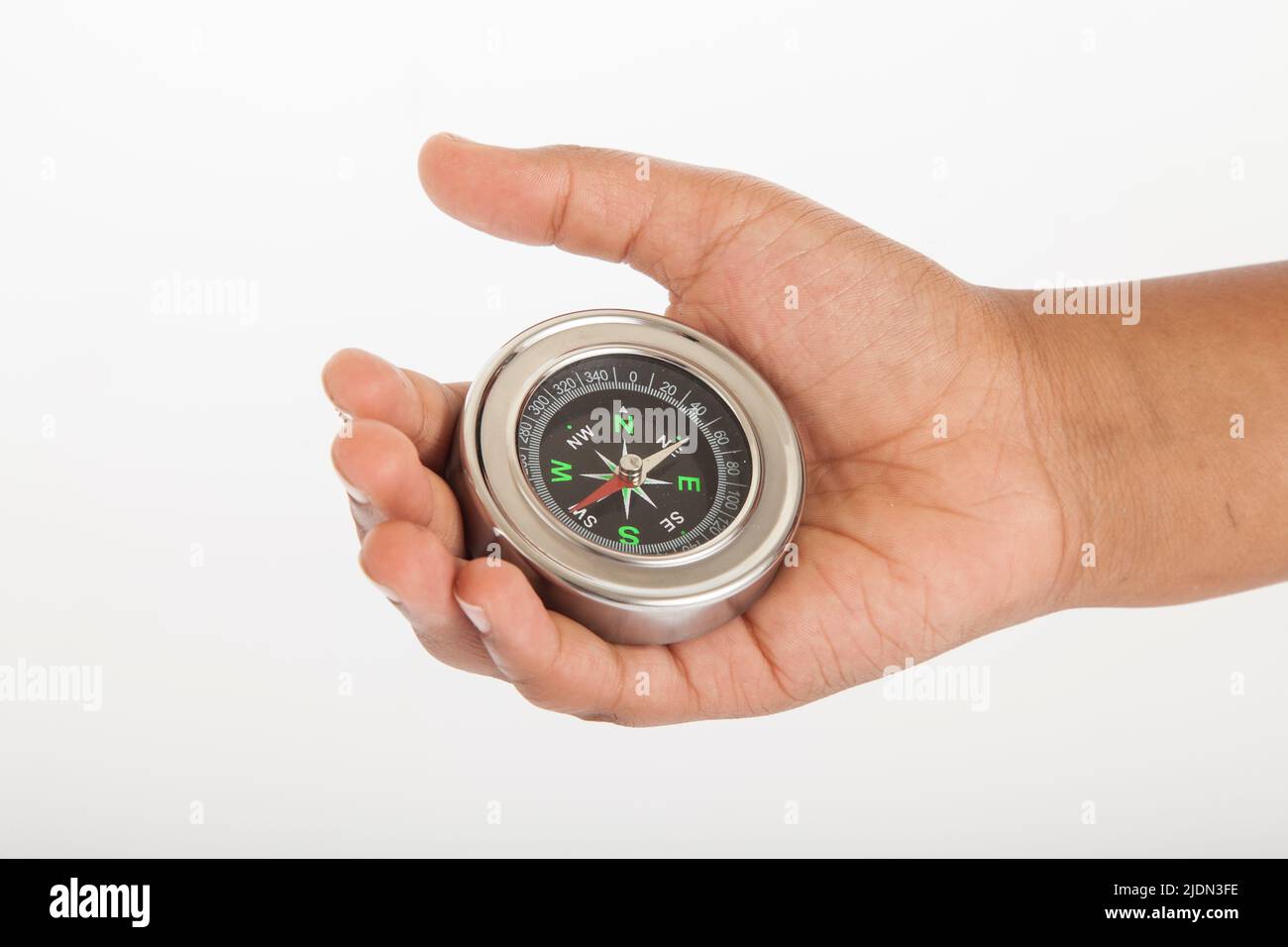 child hand holding a compass on white background Stock Photo - Alamy