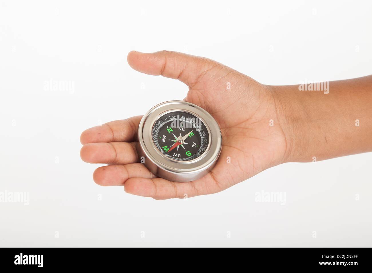 child hand holding a compass on white background Stock Photo - Alamy