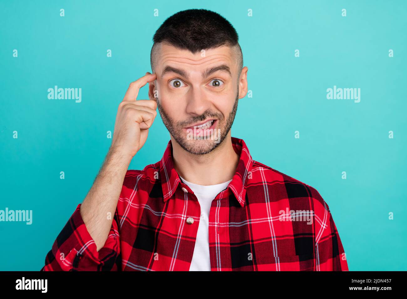 Photo of think millennial brunet guy finger head wear red shirt ...