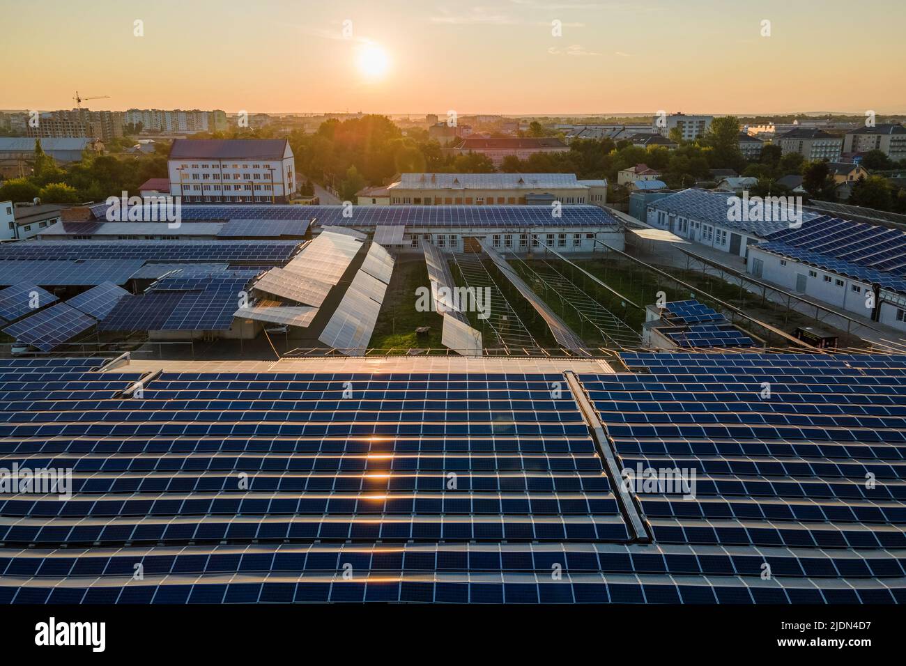 Aerial view of blue photovoltaic solar panels mounted on industrial ...