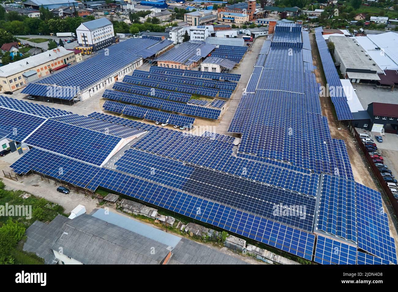 Aerial view of blue photovoltaic solar panels mounted on industrial ...