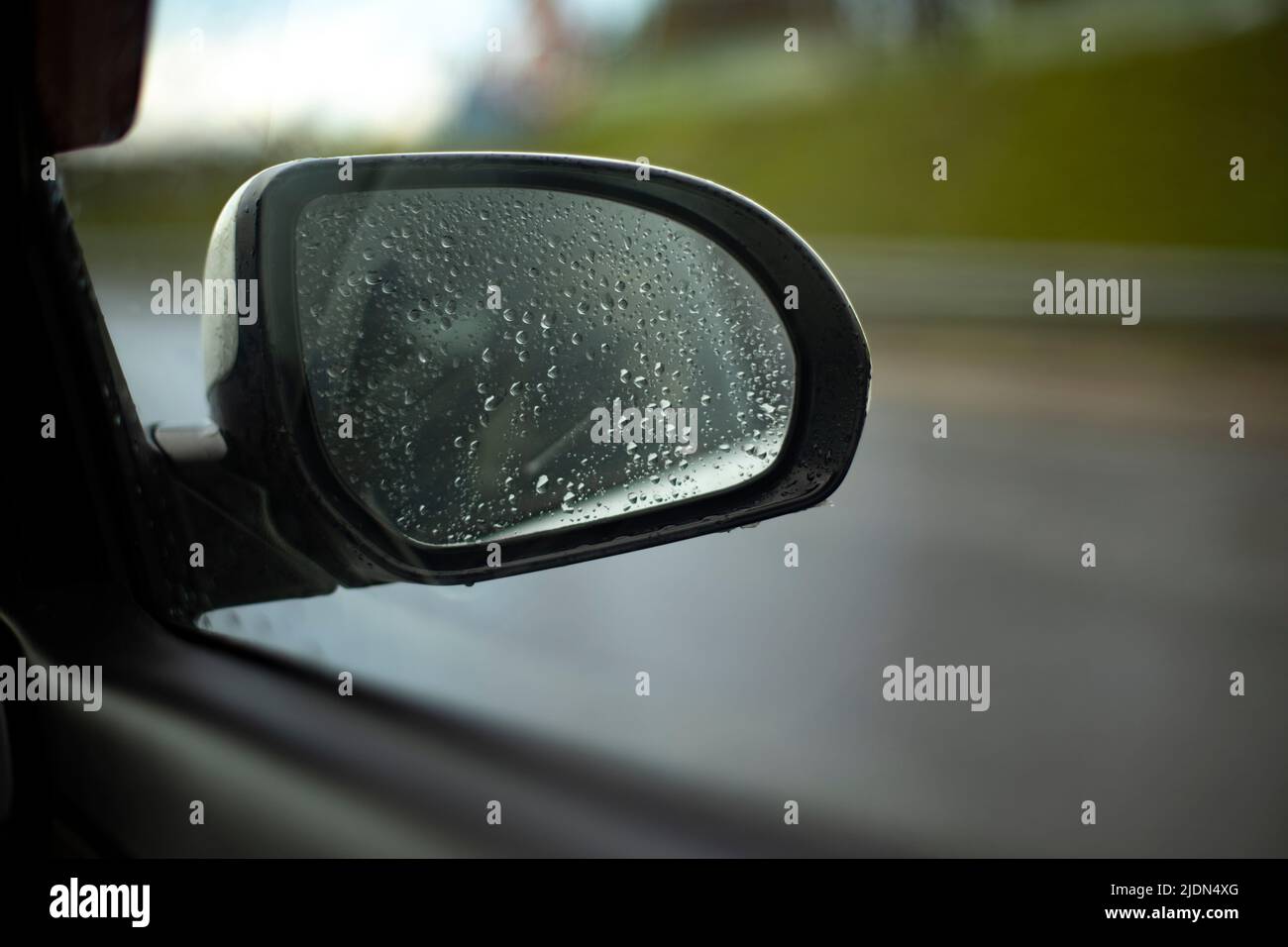 Rear-view mirror in car. Car window in rain. Transport details ...