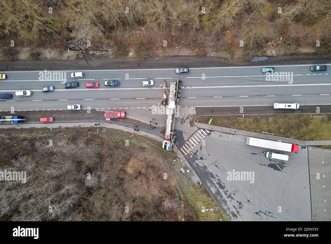 Aerial view of road accident with overturned truck blocking traffic ...