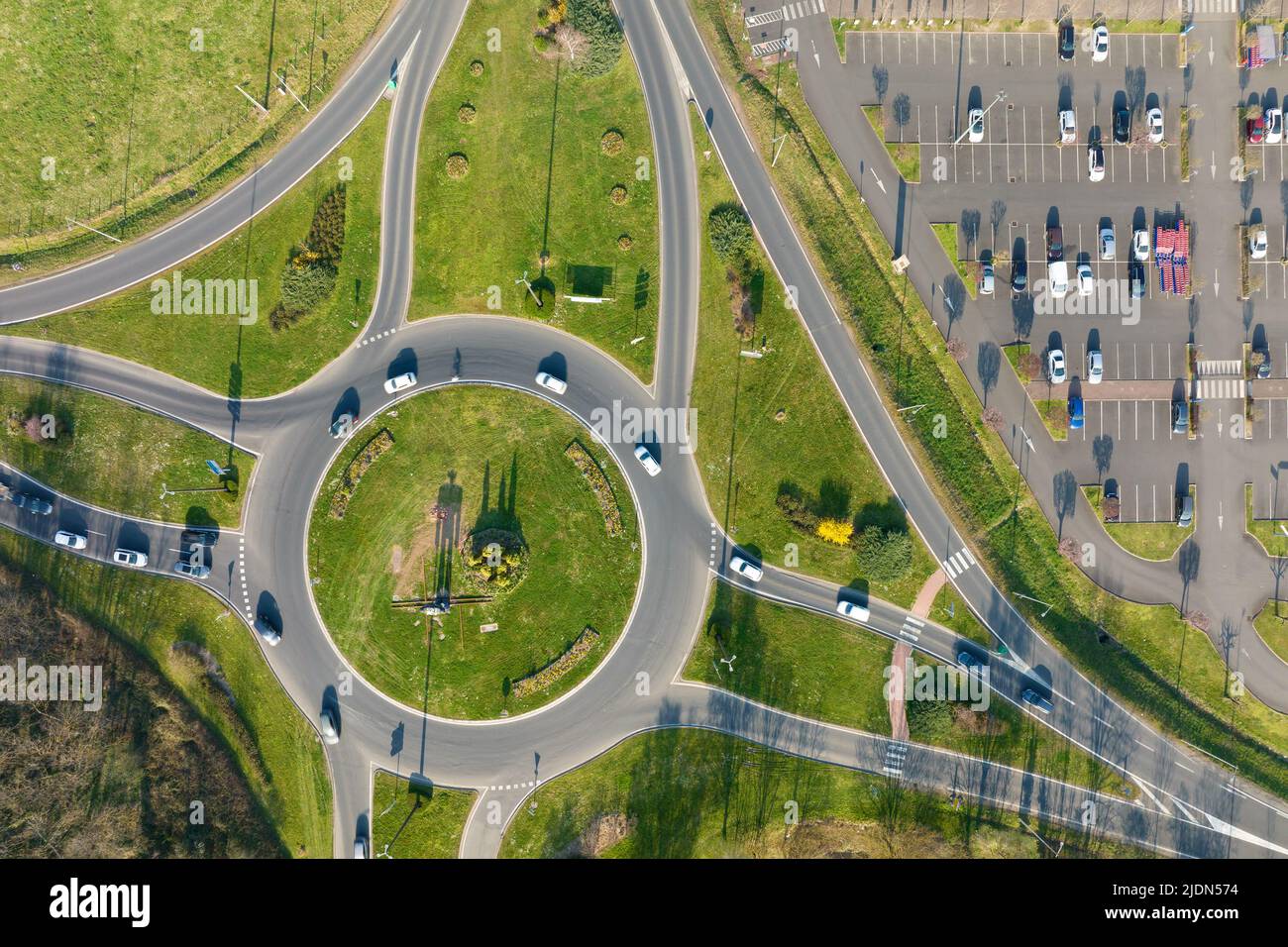 Aerial view of road roundabout intersection with moving heavy traffic ...