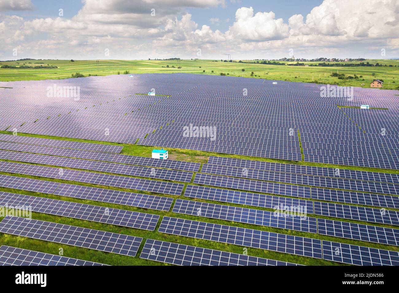 Aerial view of solar power plant on green field. Electric panels for ...