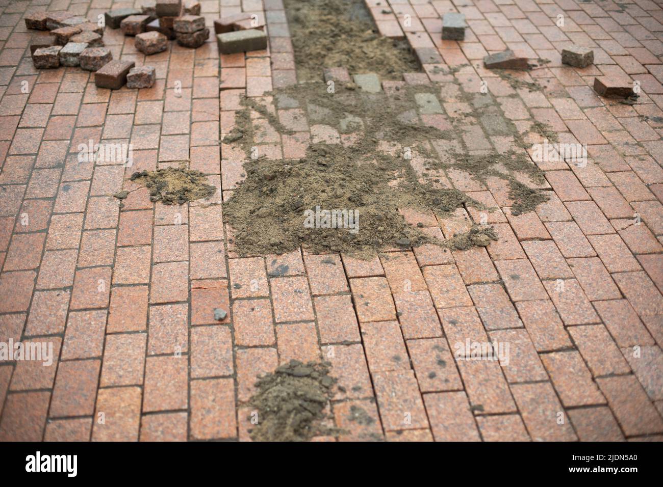 Laying tiles. Paving stones on square. Rocks on road Stock Photo - Alamy
