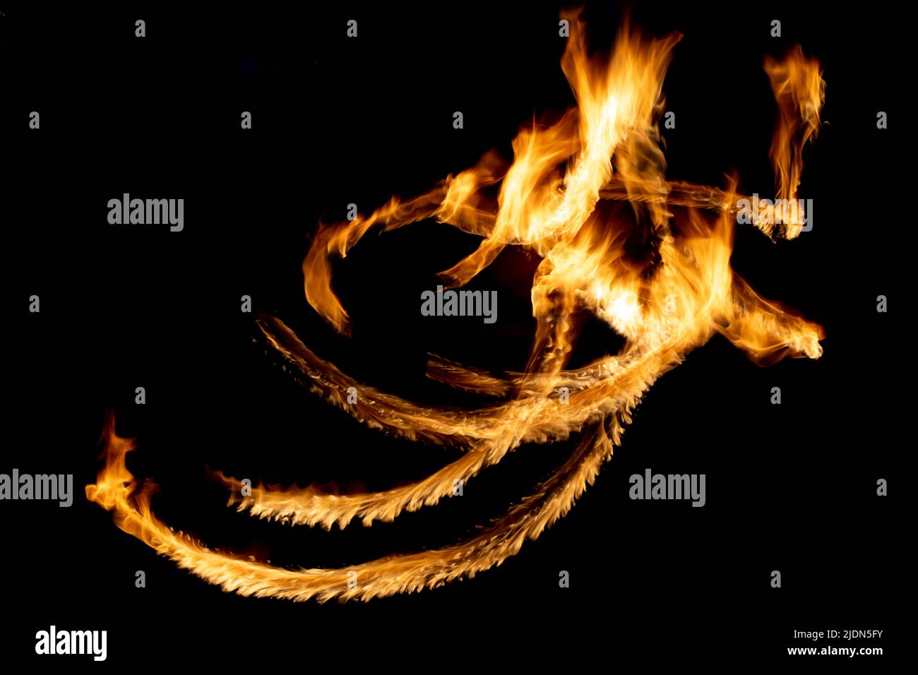 Flames in dark. Lines of fire. Fire show is shot at long shutter speed ...