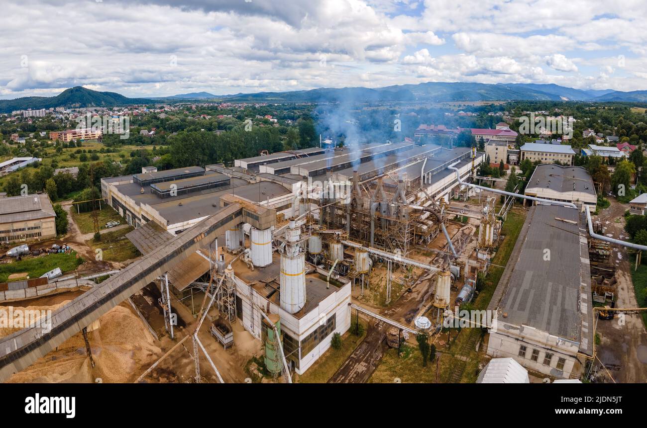 Aerial view of wood processing plant with smokestack from production ...