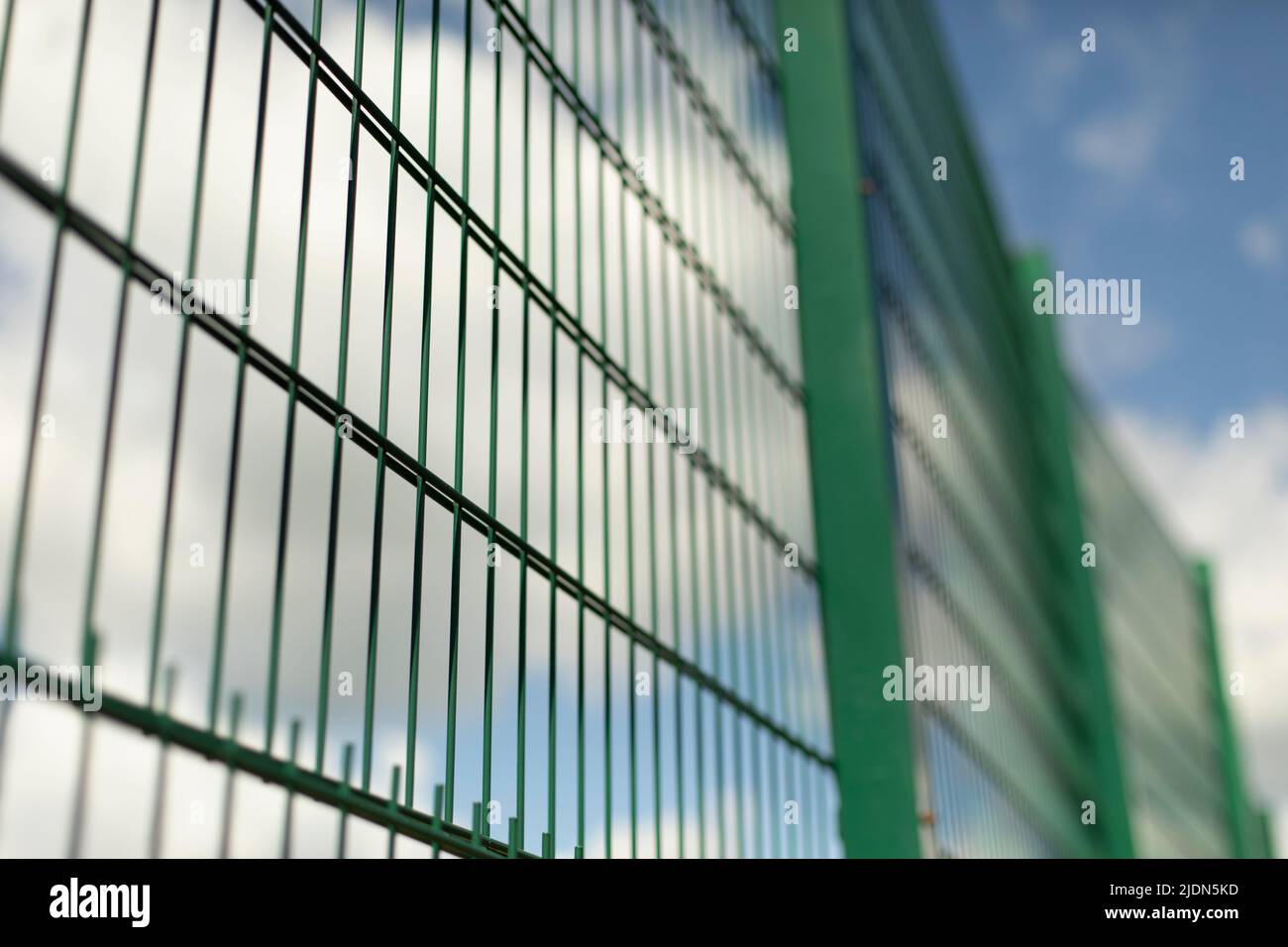 Green fence. Steel mesh on sports field. Details of metal fence Stock ...