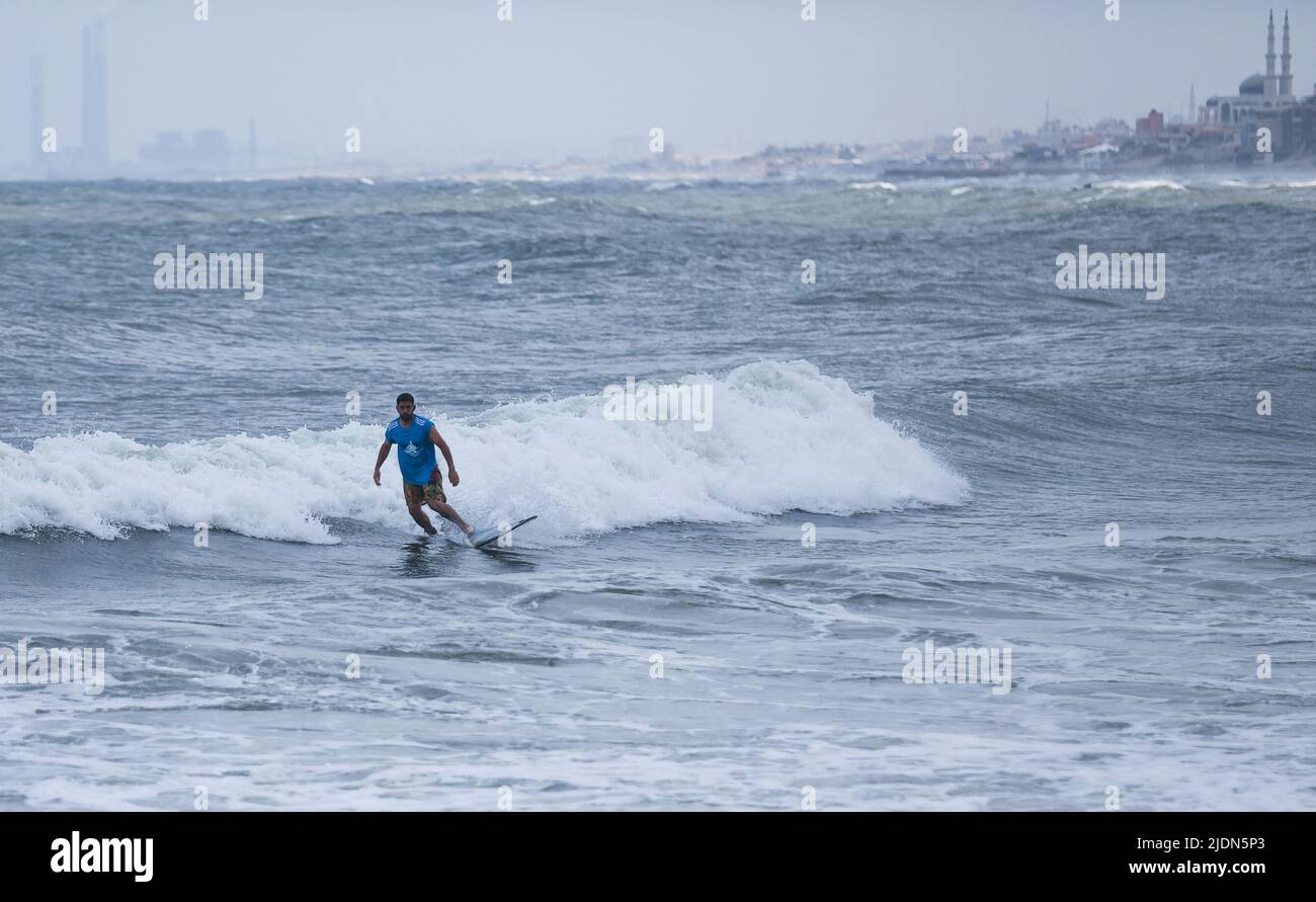 A Palestinian Athlete surfs on the waves during a surfing championship ...