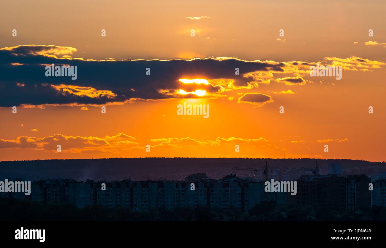Bright colorful sunset sky with rays of setting sun and vivid dark ...