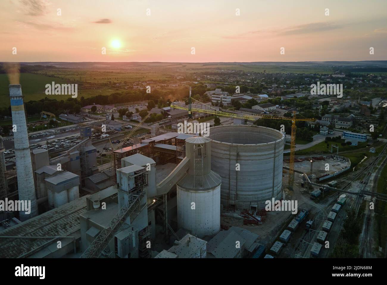 Cement plant with high factory structure and tower cranes at industrial ...