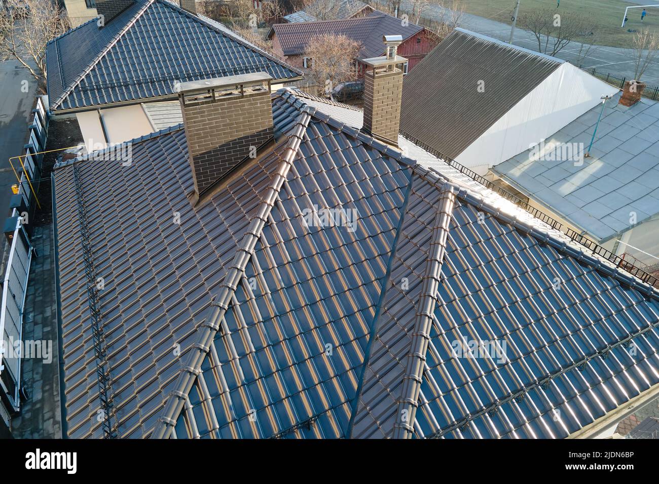 Closeup of house roof top covered with ceramic shingles. Tiled covering ...