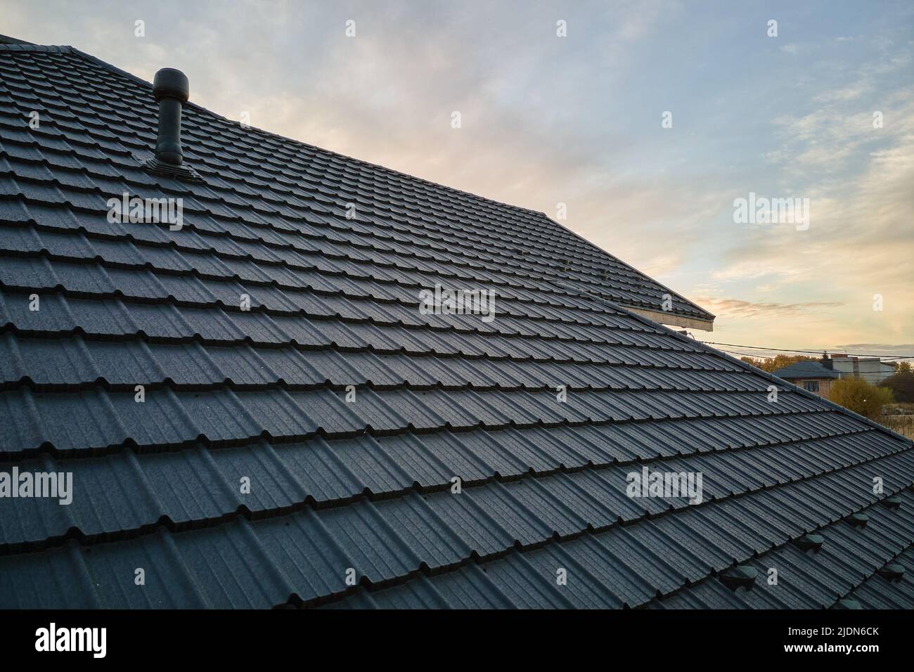 Closeup of house roof top covered with ceramic shingles. Tiled covering ...