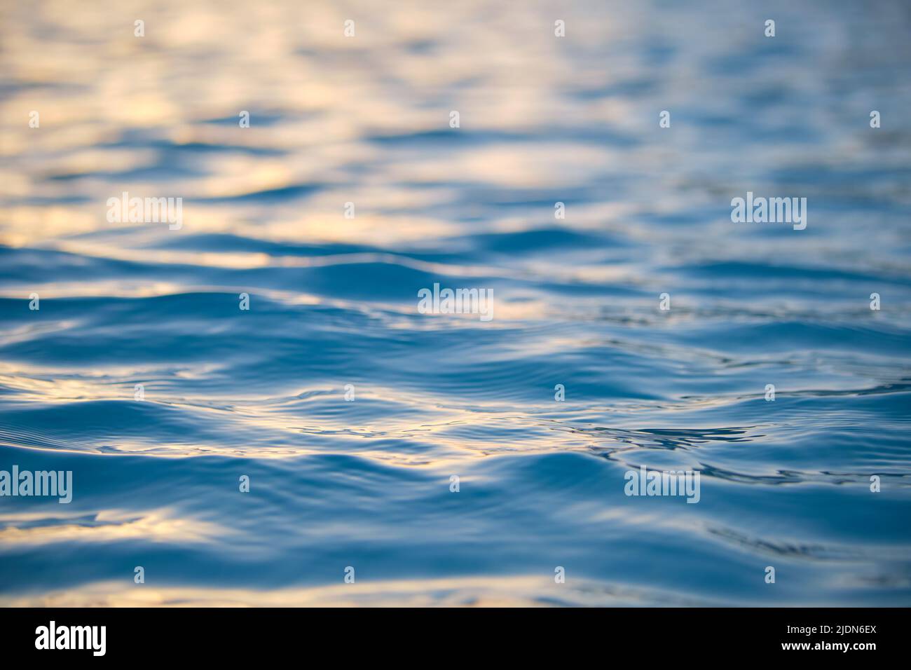 Closeup seascape surface of blue sea water with small ripple waves ...