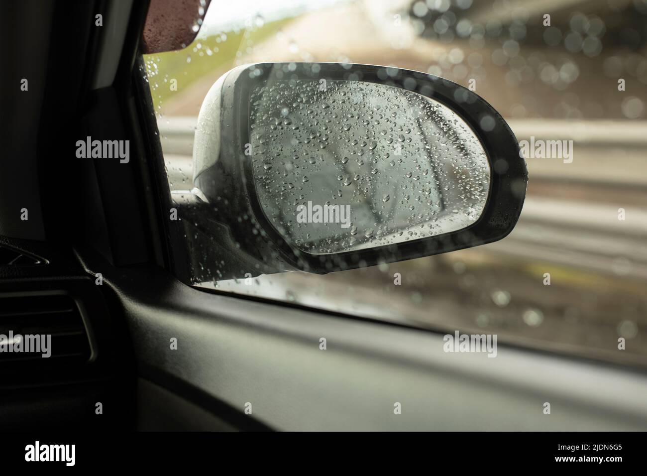 Rear-view mirror in car. Car window in rain. Transport details ...