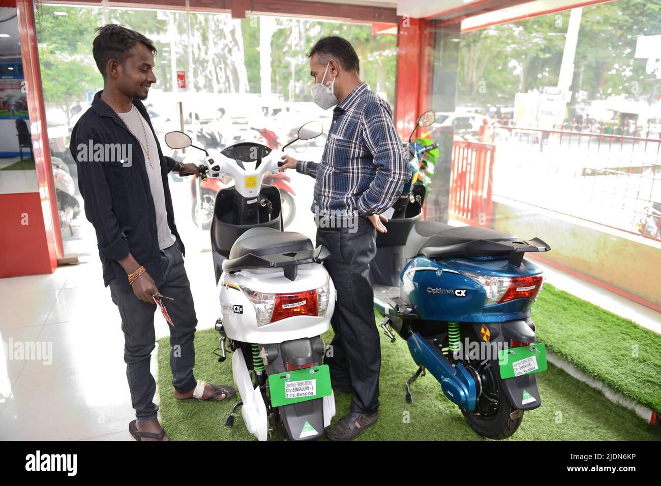 A salesman attends to a costumer at the Hero Electric Showroom. Hero ...