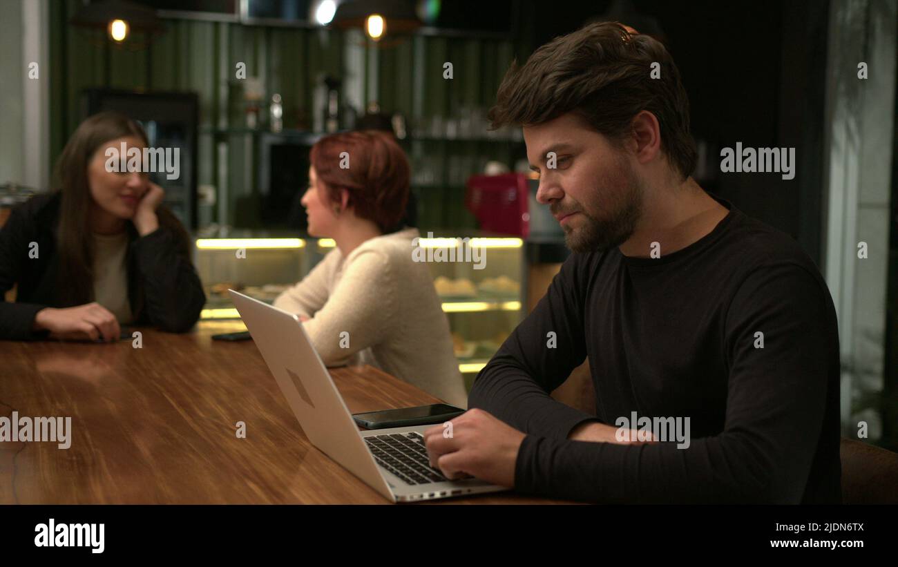 Young man doing his work inside coffee shop studying or working in ...
