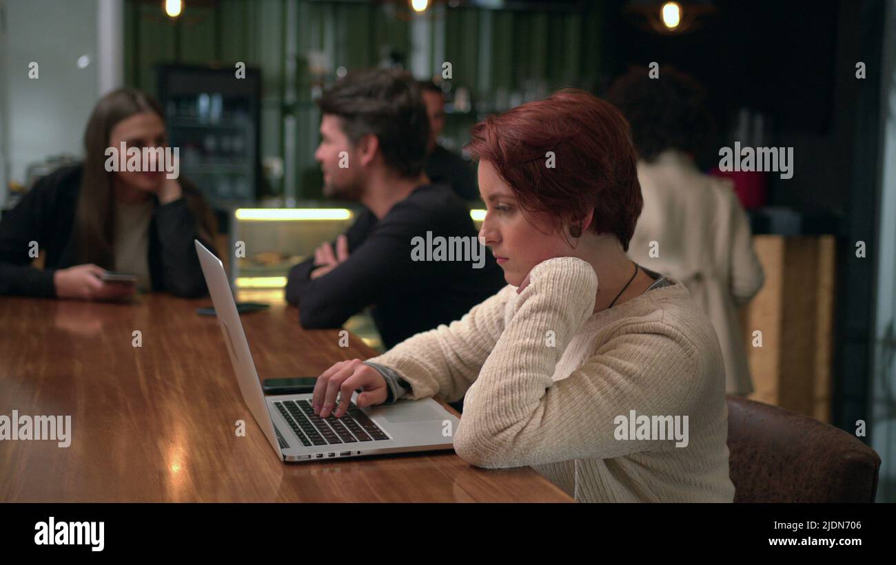 People inside coffee shop. Young woman browsing internet in front of ...